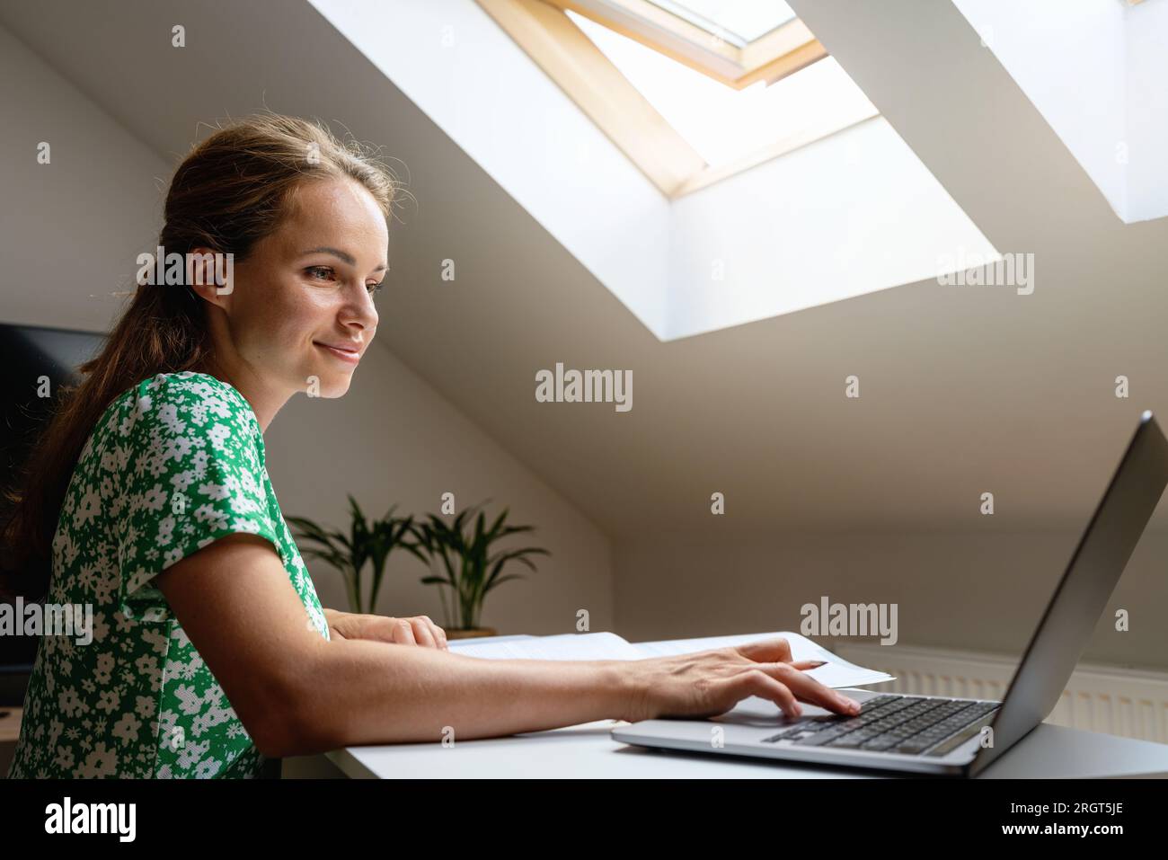 Adult female university student studying at home using e-learning ...