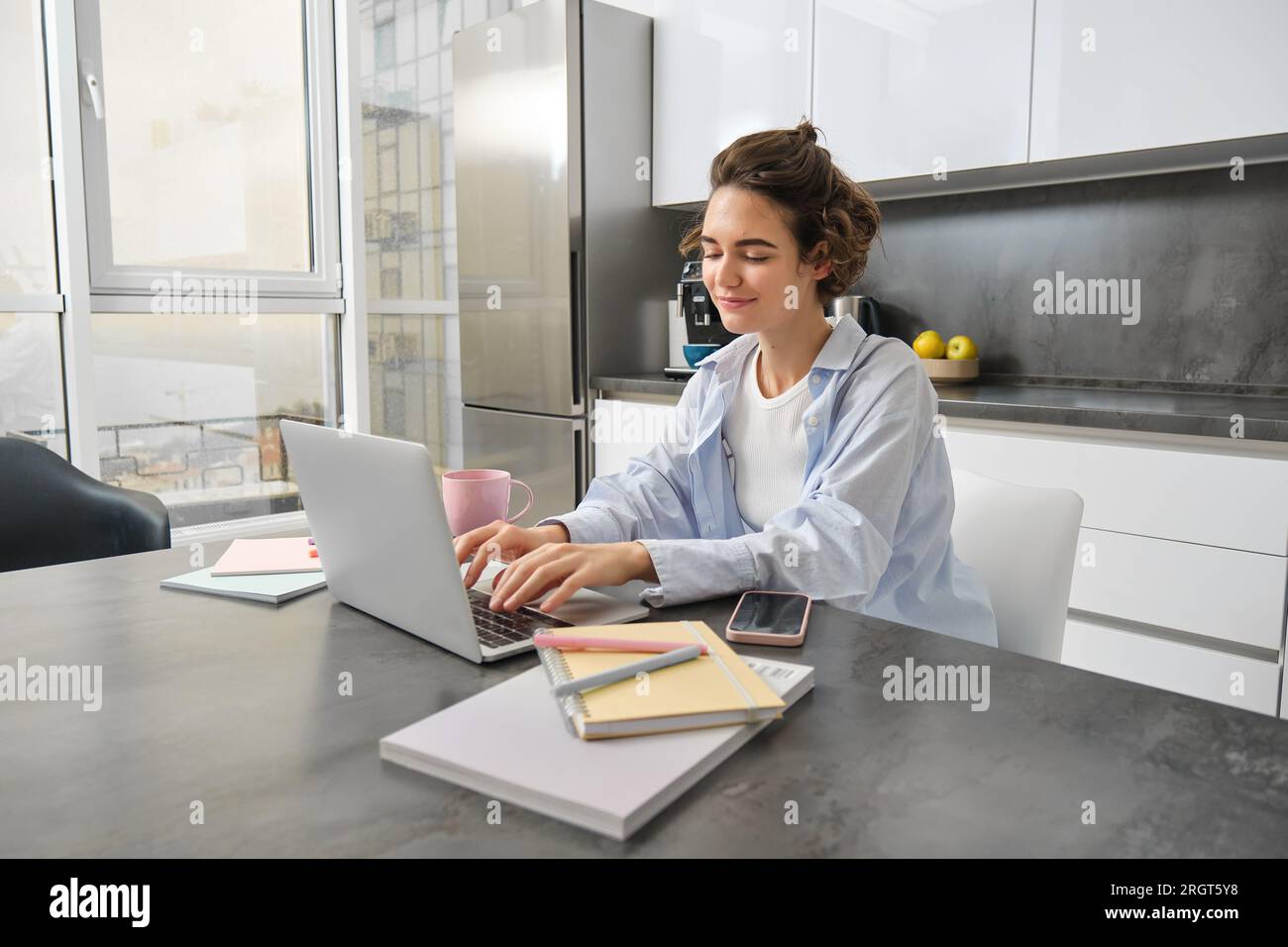 Portrait of hardworking woman studying from home, typing on laptop ...