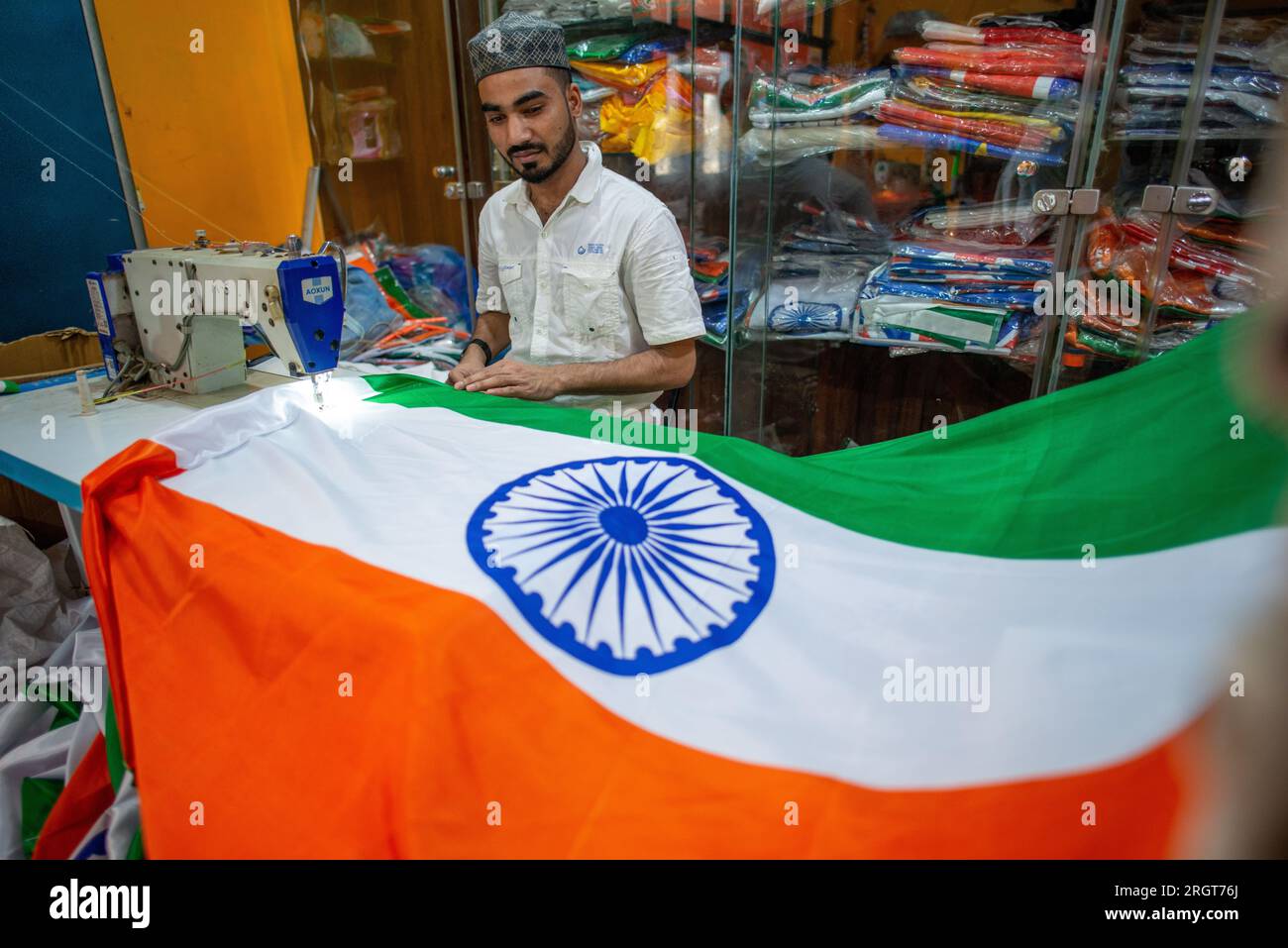 New Delhi, India. 11th Aug, 2023. A Muslim man stitching National Flags ...