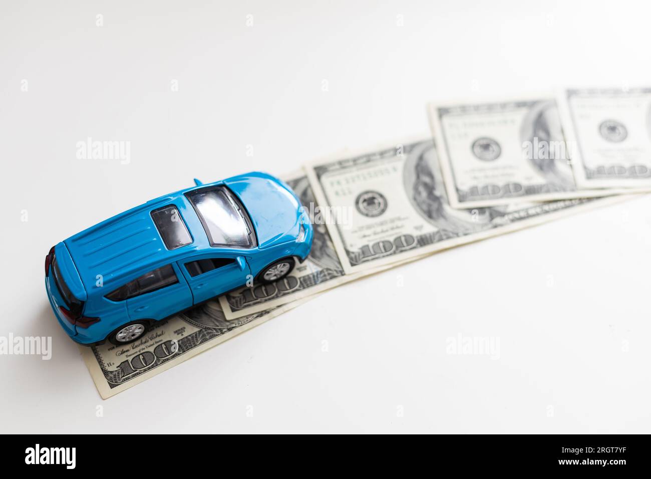 Toy car on money road isolated on white background Stock Photo - Alamy