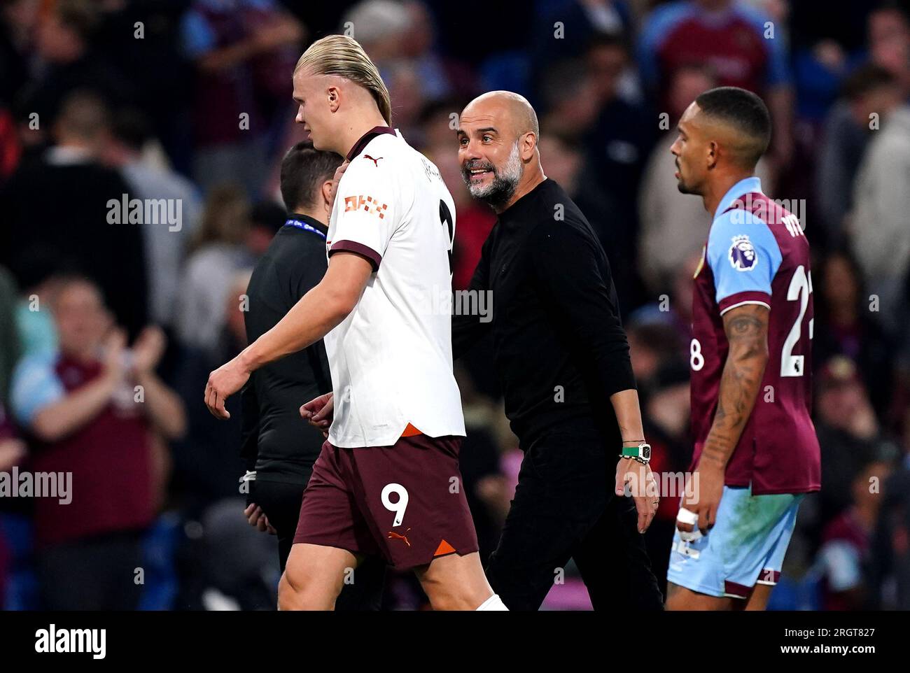 Manchester City manager Pep Guardiola speaks to player Erling Haaland (left) at half time during ...