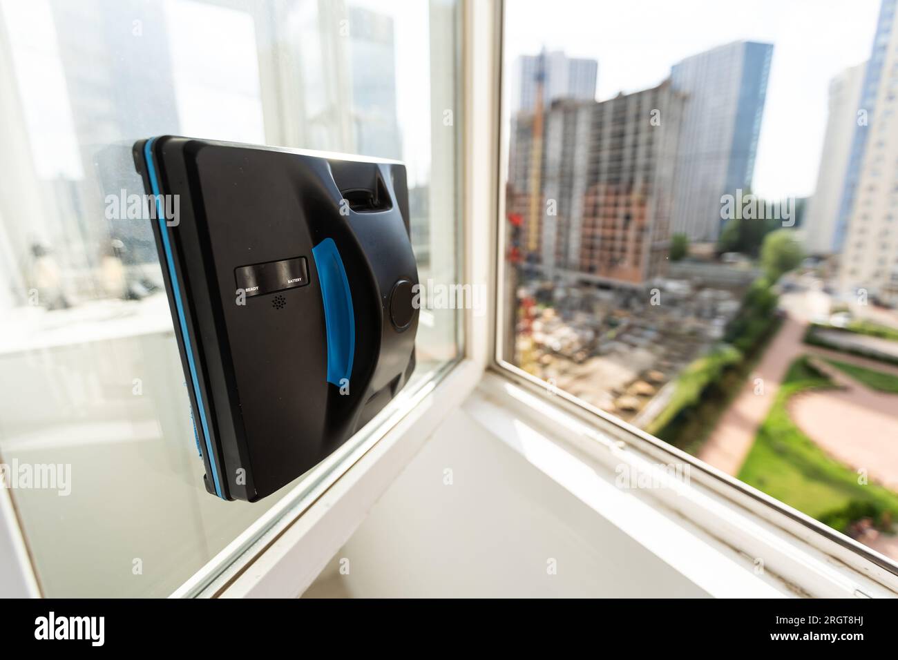 The white robotic window cleaner uses a brush and vacuum for a thorough ...