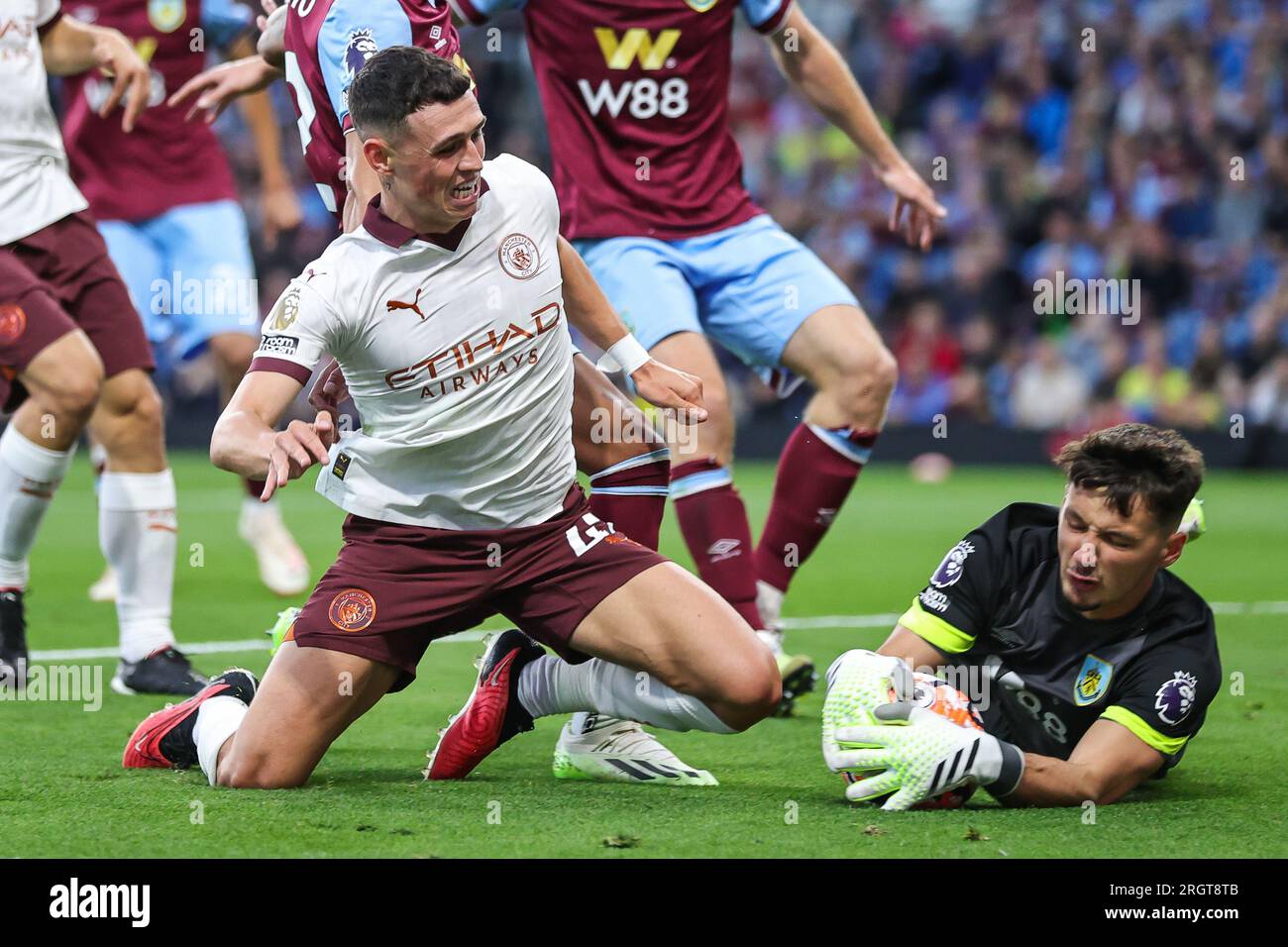James Trafford of Burnley makes a save at the feet of Phil Foden of ...