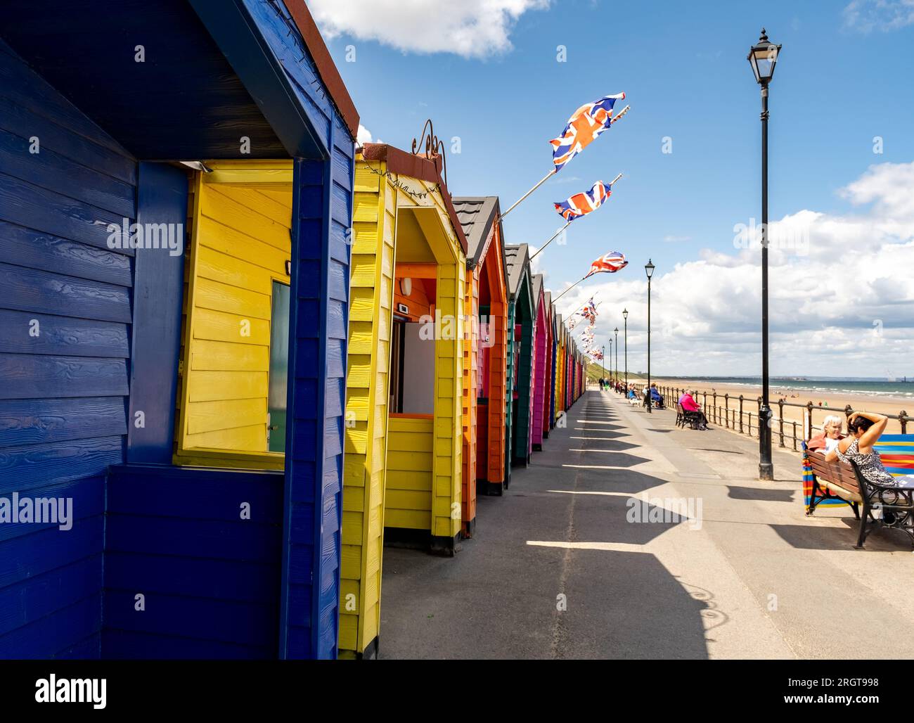Colourful beach huts on the promenade in the seaside town of Saltburn ...