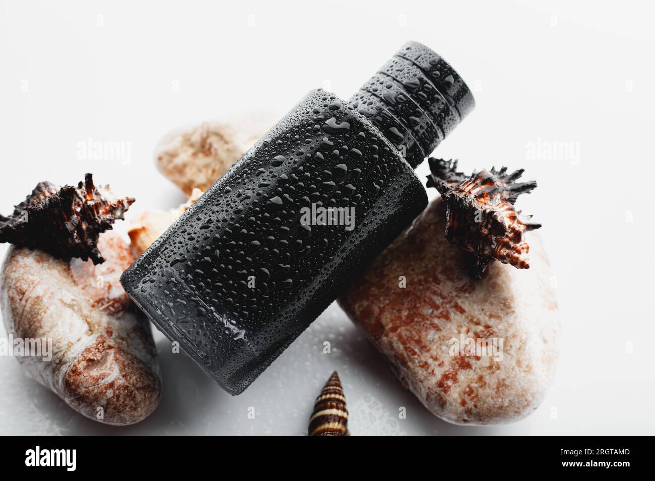 Perfume concept with sea notes. Frosted glass perfume bottle with sea ...