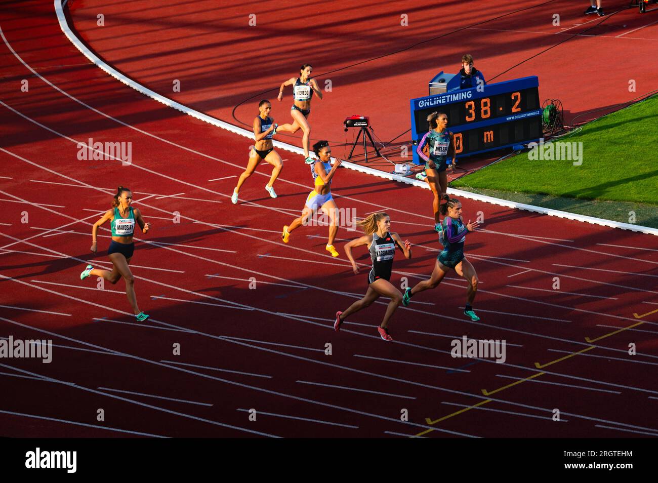 OSTRAVA, CZECHIA, JUNE 27, 2023: 400m Female Race in Bend Showcasing Interplay of Light and ...
