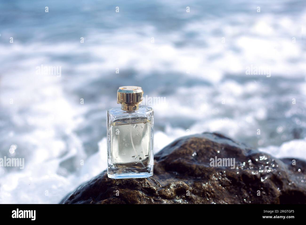 Perfume bottle on sea background Stock Photo - Alamy