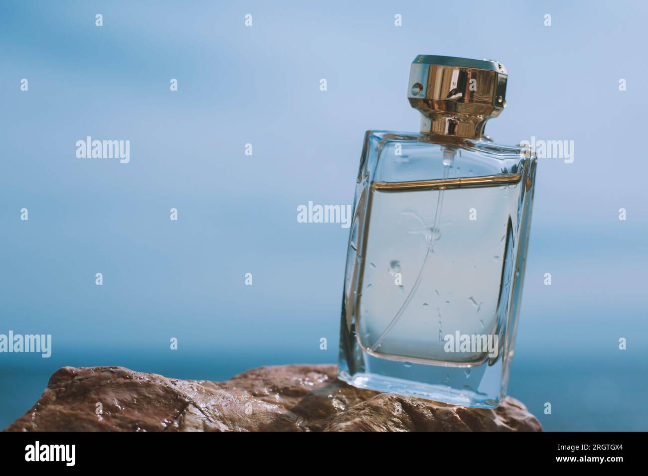 Perfume bottle on sea background Stock Photo - Alamy