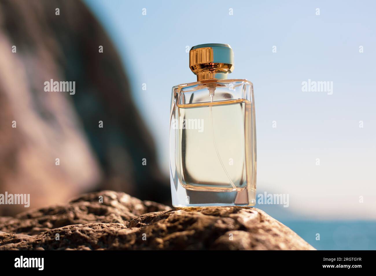 Perfume bottle on sea background Stock Photo - Alamy