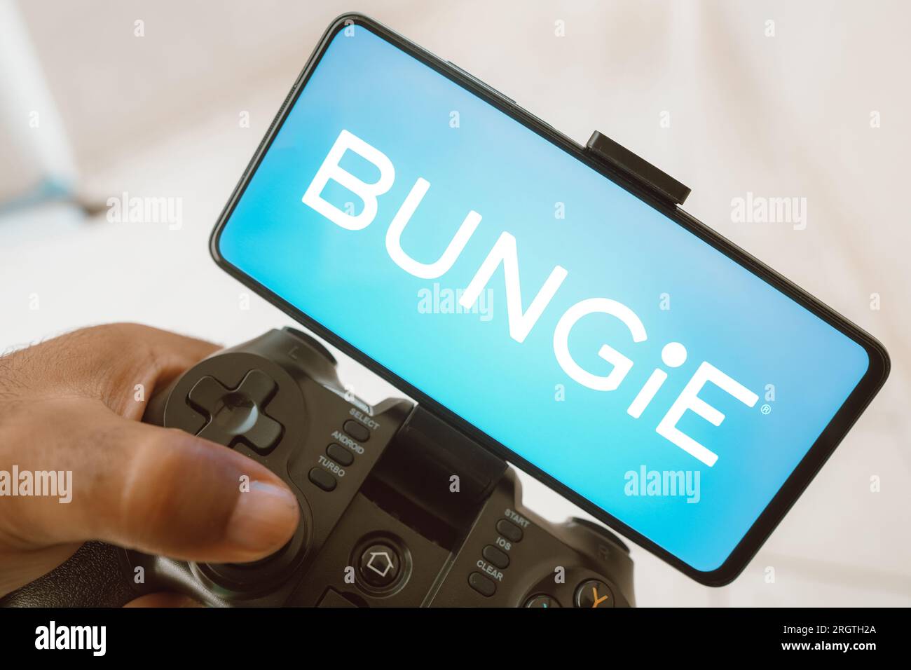 In this photo illustration, a person plays on a joystick and the Bungie ...