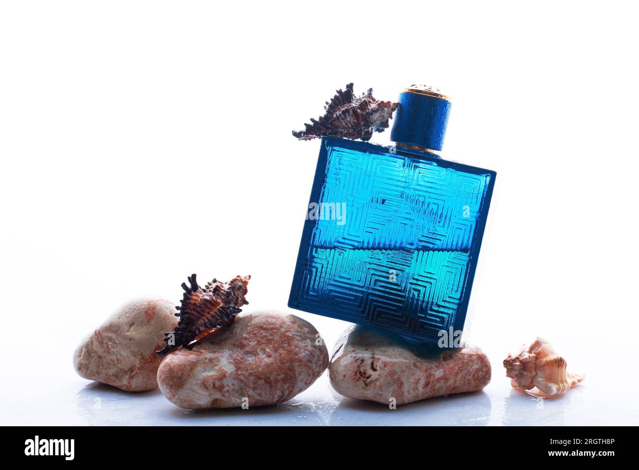 Perfume concept with sea notes. Frosted glass perfume bottle with sea ...
