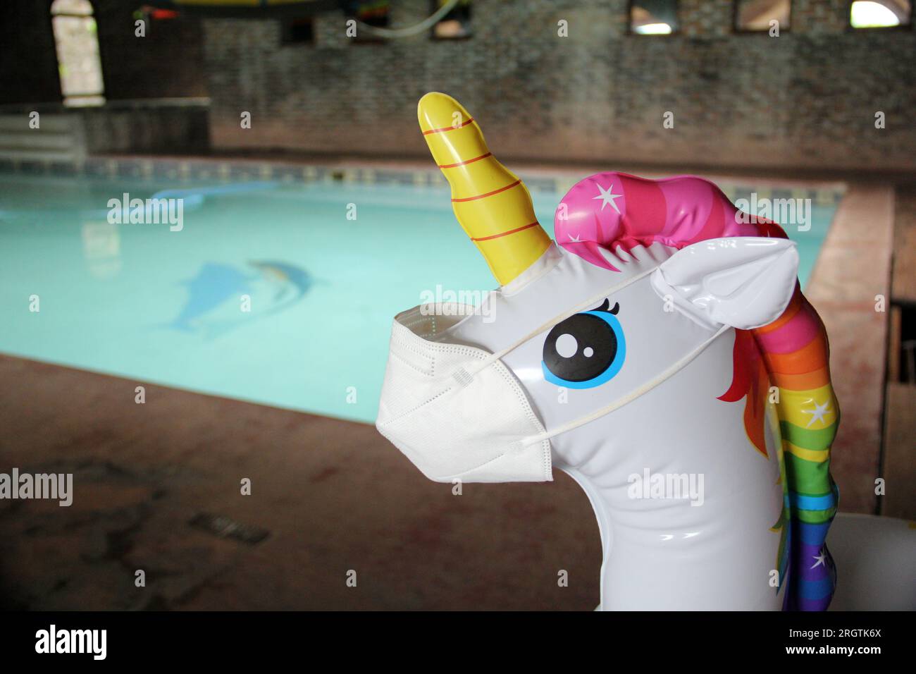 Pool to play on vacation next to flip-flops and an inflatable unicorn ...