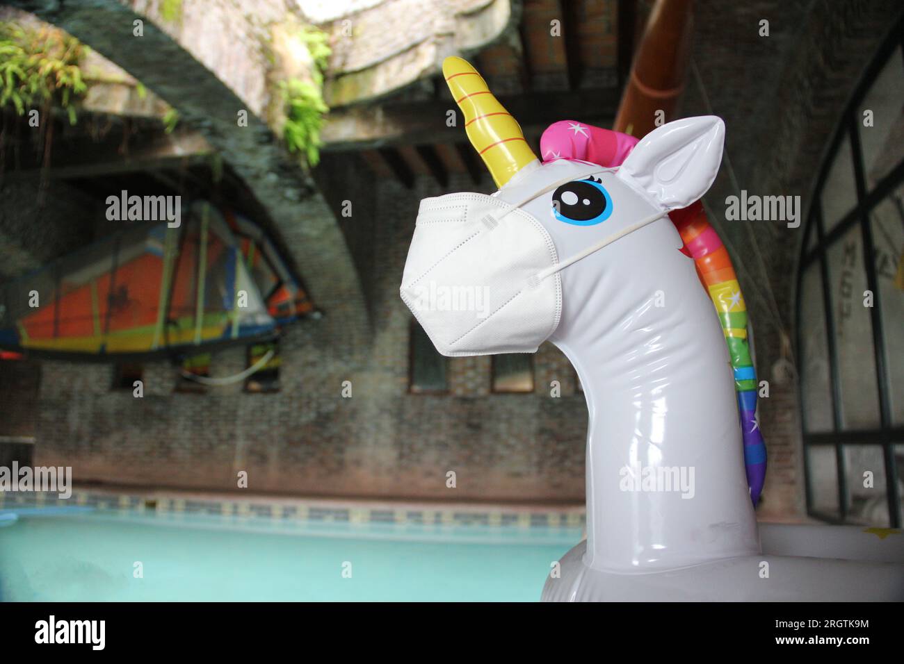 Pool to play on vacation next to flip-flops and an inflatable unicorn ...