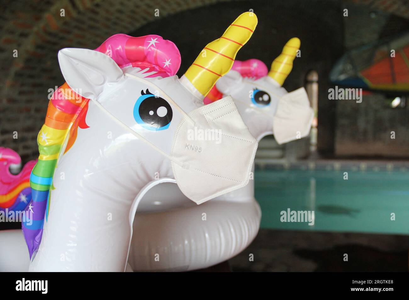 Pool to play on vacation next to flip-flops and an inflatable unicorn ...
