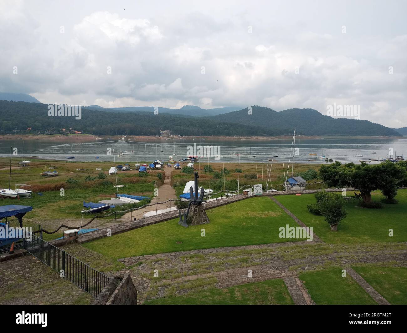 Port of small and large sailboats parked and sailing on the lake of ...