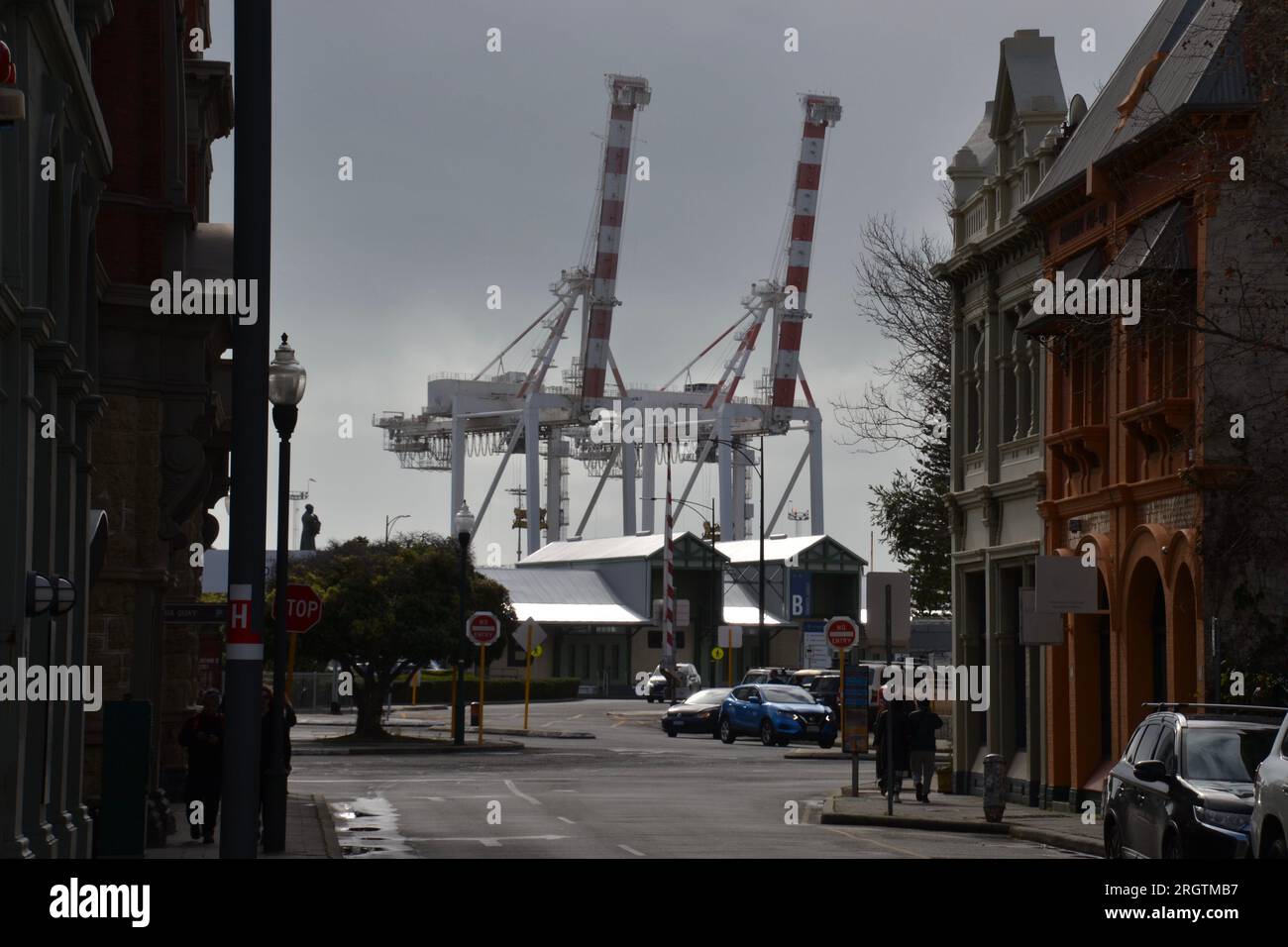 Two industrial dock cranes as viewed from a historic Victorian street ...
