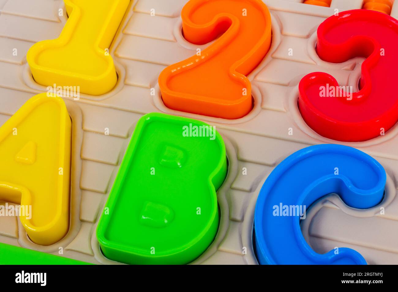 Close up photo of kids toy multi colored numbers and alphabet letters ...