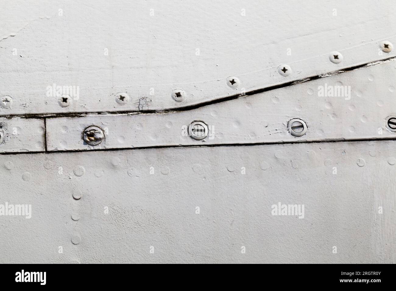 aluminum sheets joined together by welding and riveting, close up of ...