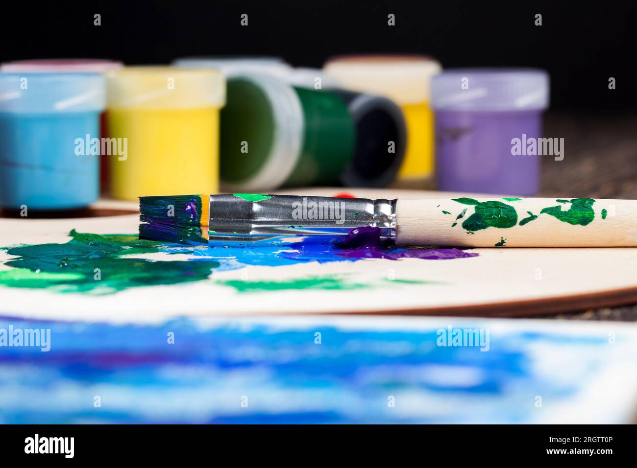 the creative process of drawing by mixing different colors of paints ...
