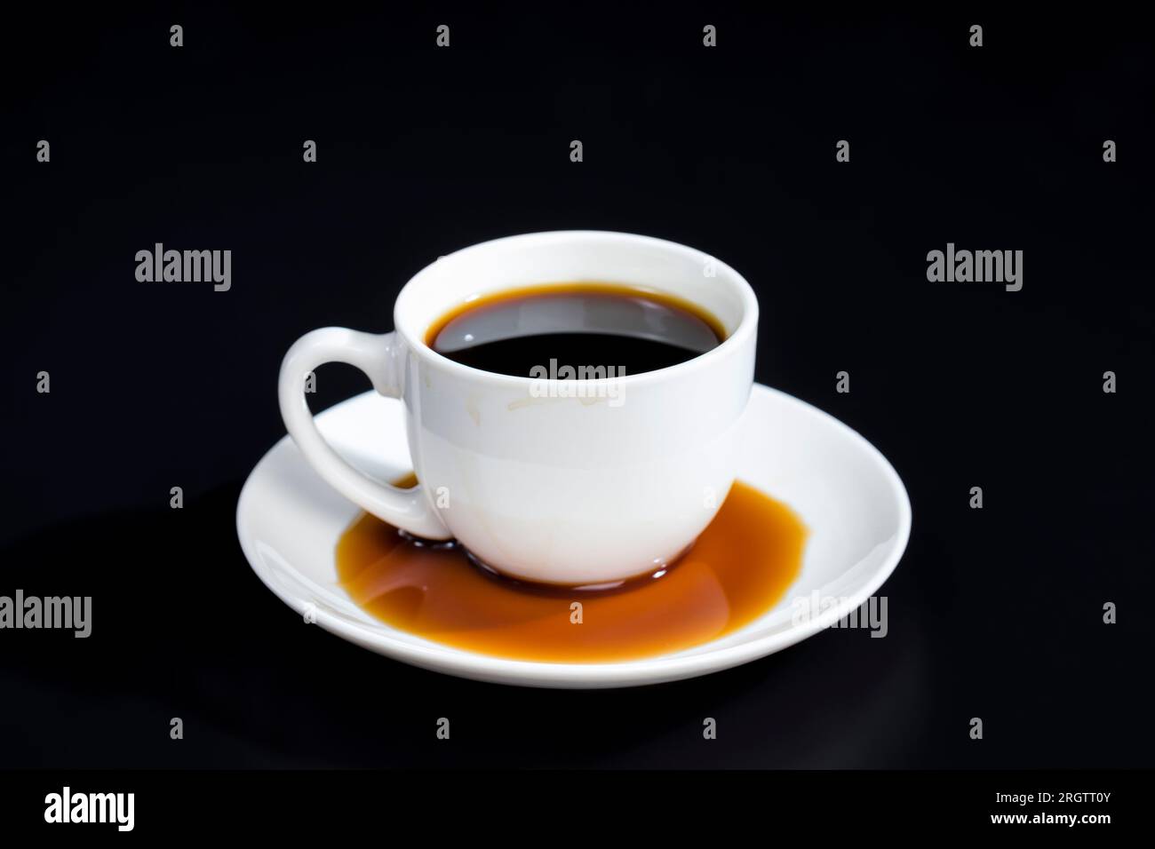 black aromatic coffee spilled due to carelessness, close up of glass ...