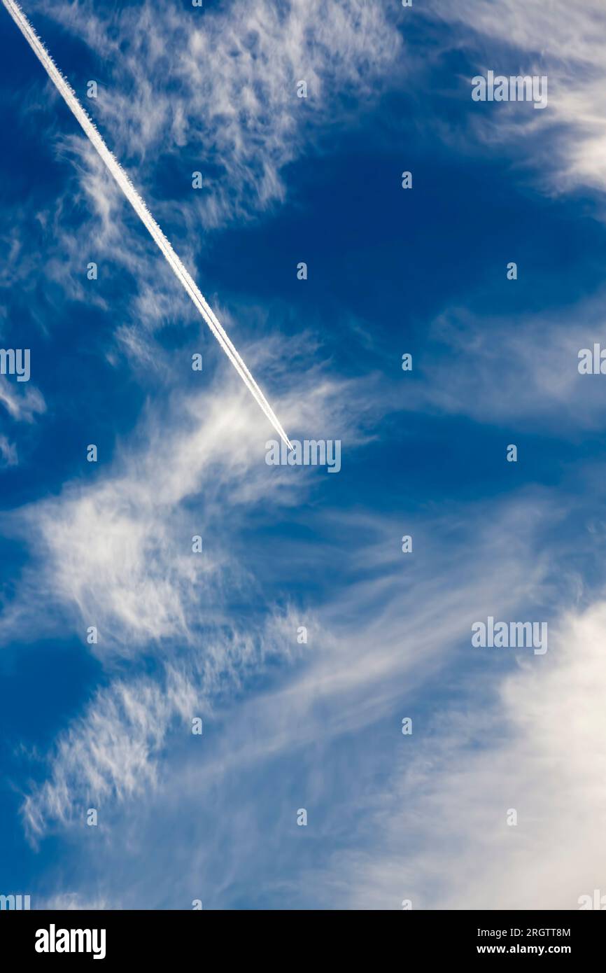 passenger plane flying in the blue sky, fast transport leaves behind a ...