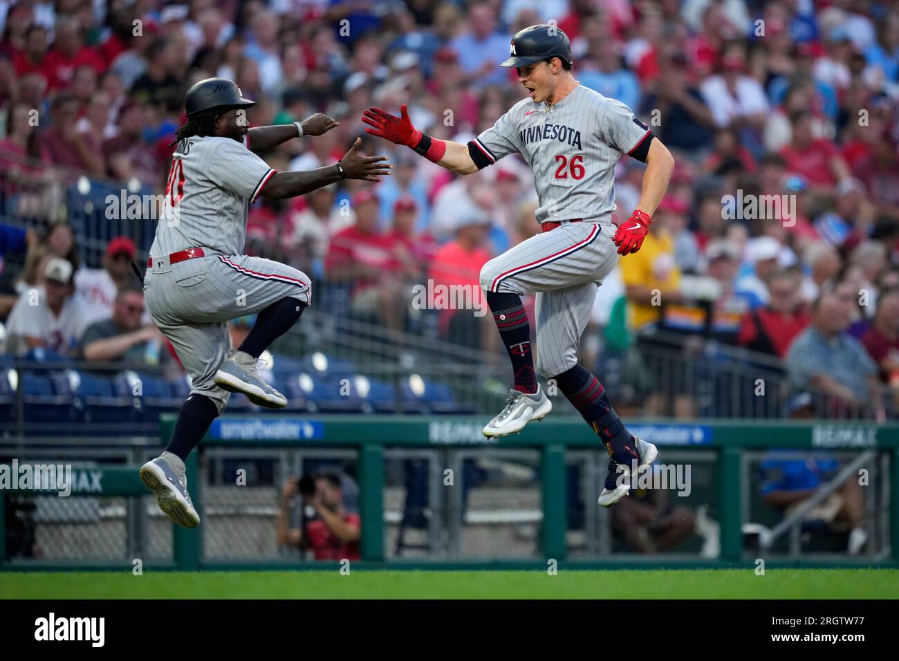 Minnesota Twins' Max Kepler, right, and third base coach Tommy Watkins ...