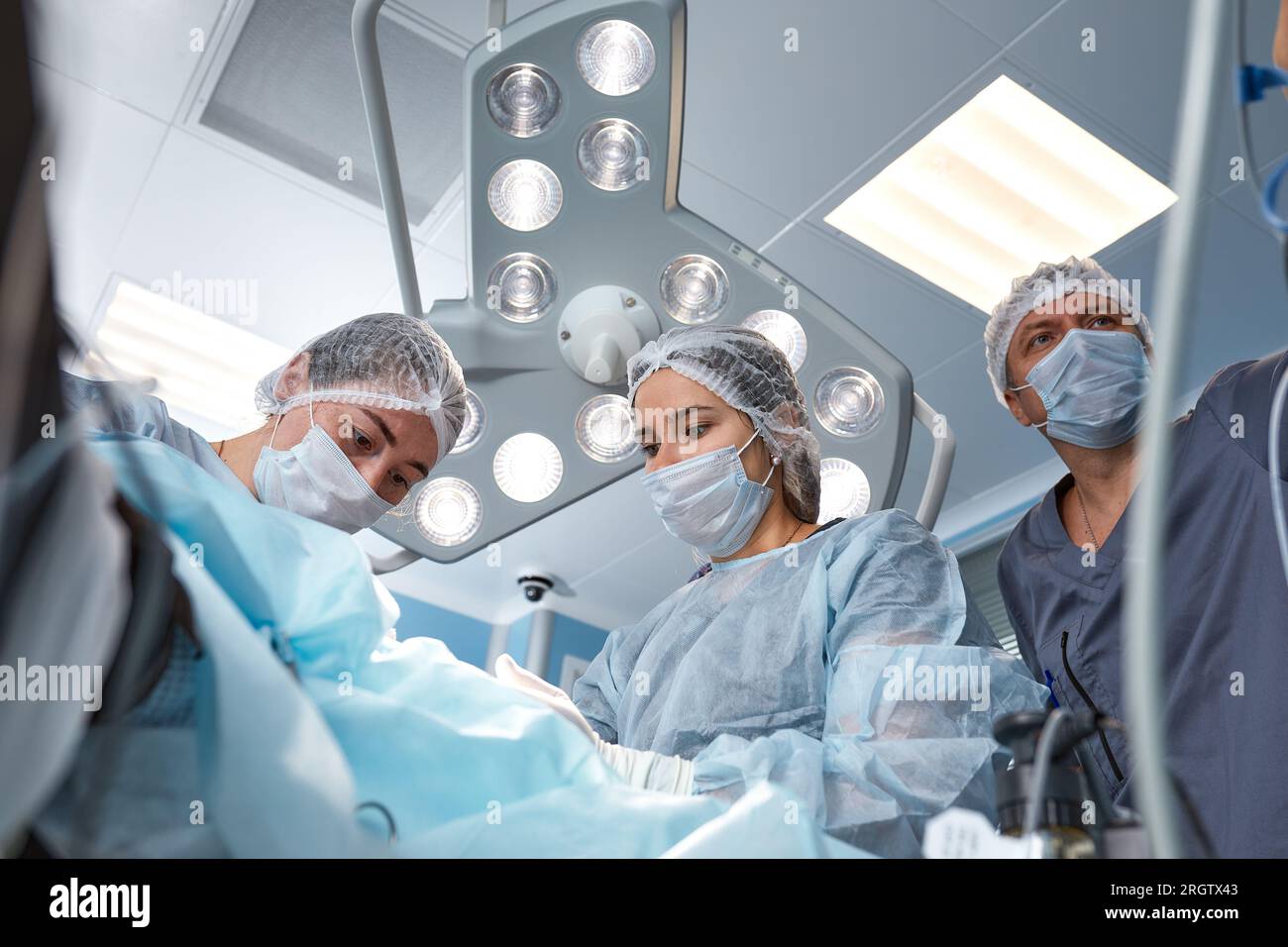 Concentrated Surgical team operating a patient in an operation theater ...
