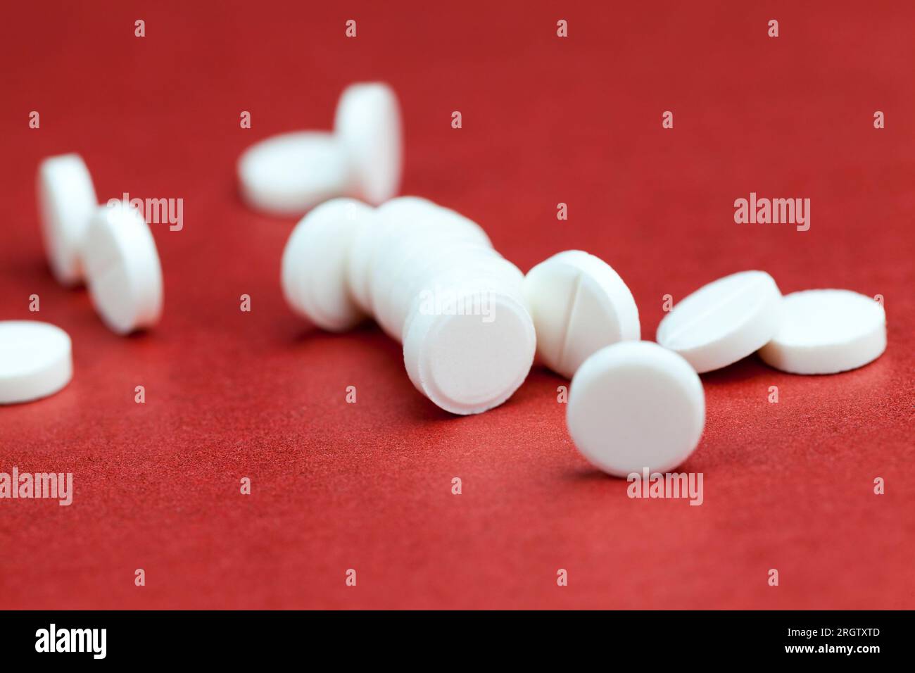 medicines for the treatment of diseases scattered on a red background ...