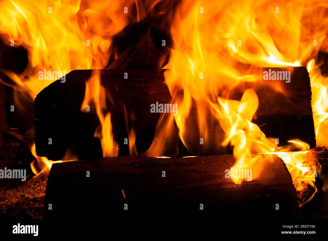 burning logs in the fire of a barbecue or stove or fireplace, the flame ...