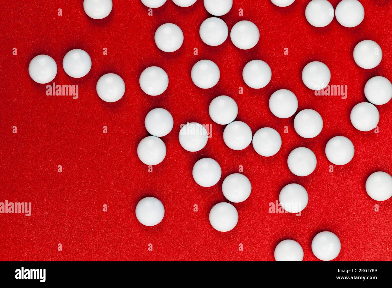 medicines for the treatment of diseases scattered on a red background ...