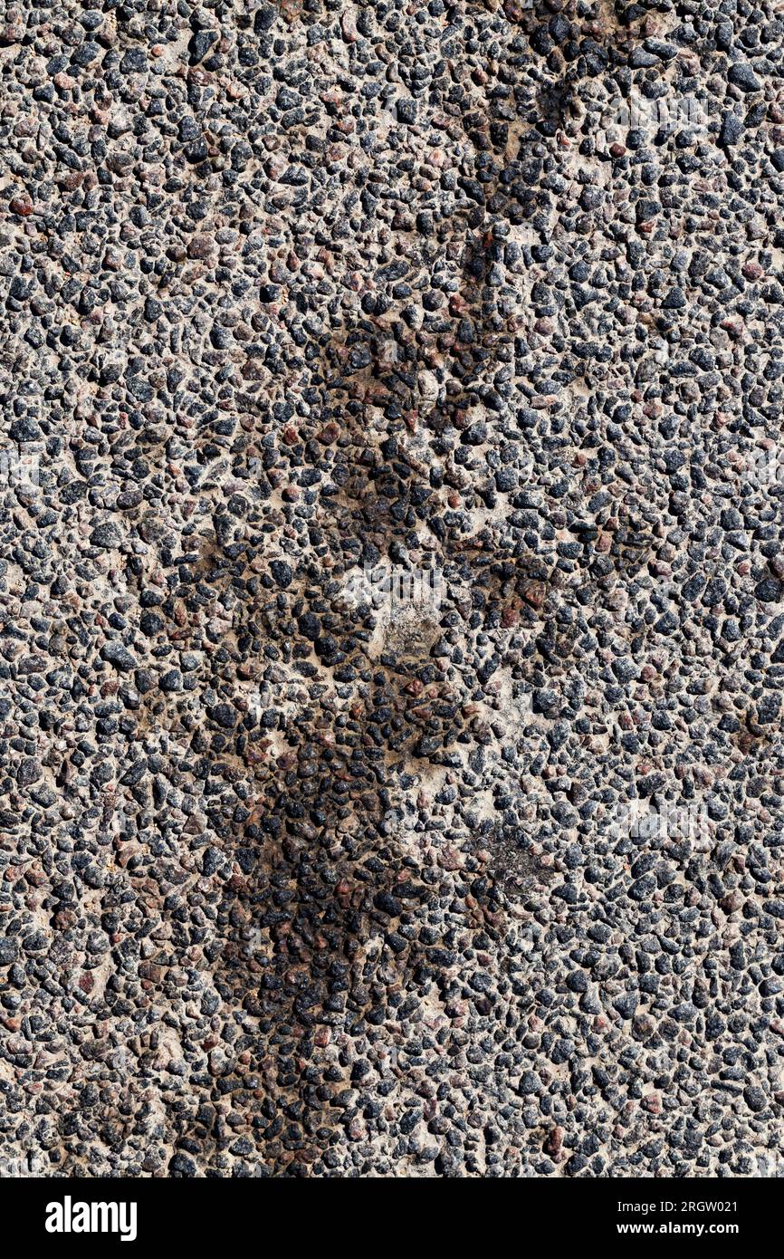 traces of road repairs, part of an asphalt road with damage and stains ...