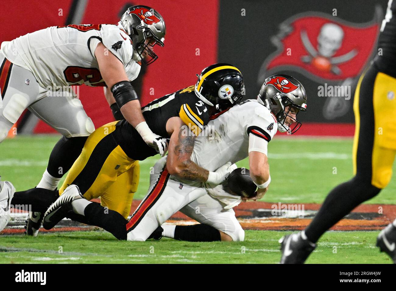 Tampa Bay Buccaneers quarterback Kyle Trask, right, is sacked by ...