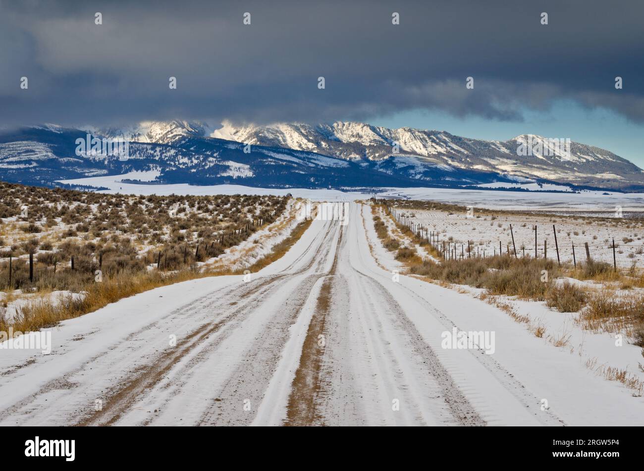 Rural road, the Bridger Mountains and low clouds in winter. Gallatin ...