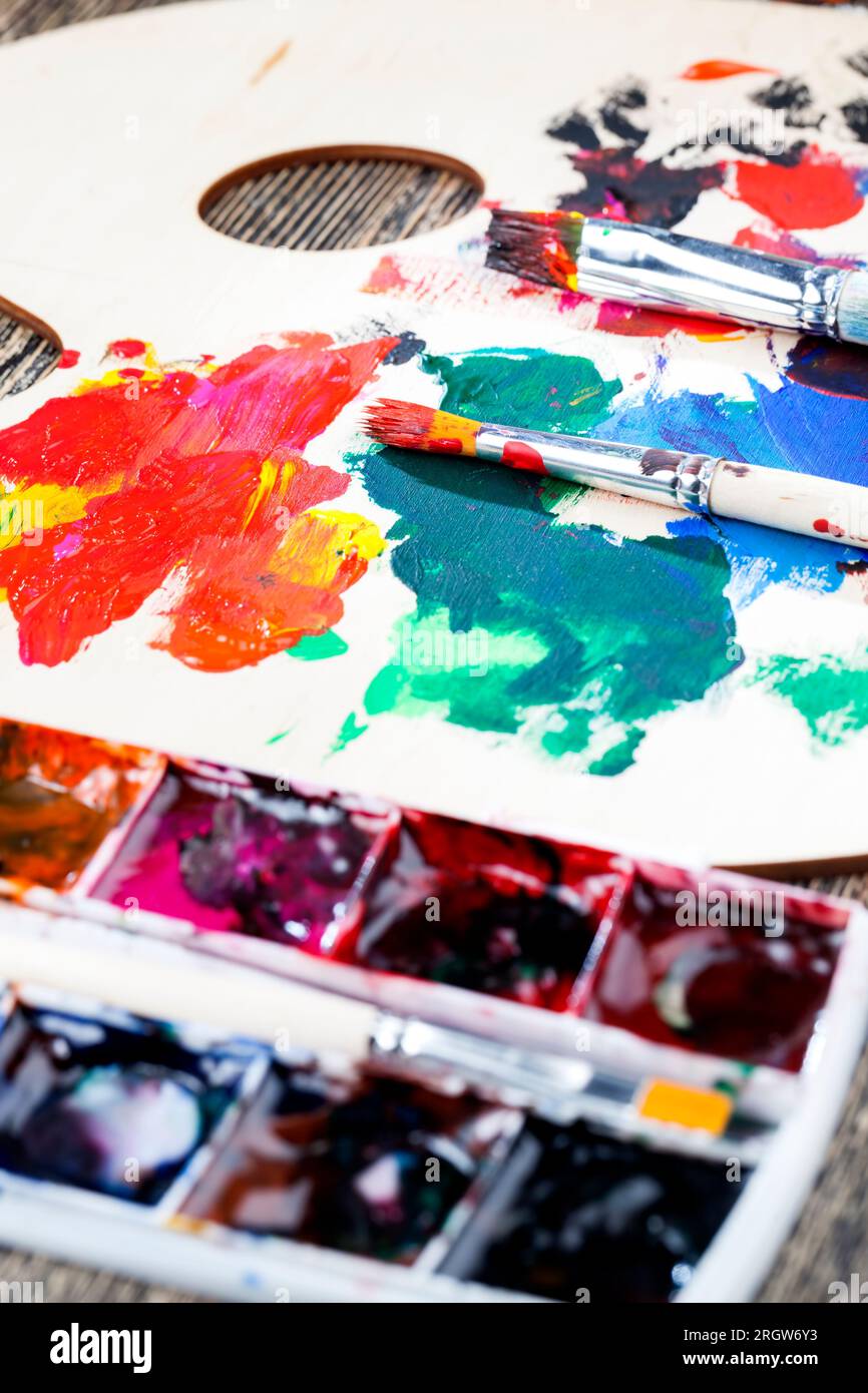 mixed on a wooden palette of multi colored paints, the paint is used ...