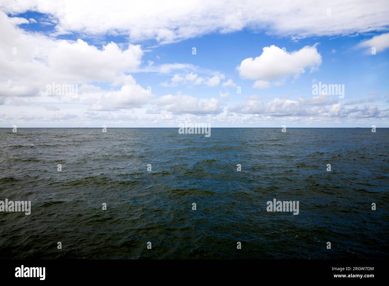 cold windy weather in August, sea coast with lots of waves from windy ...