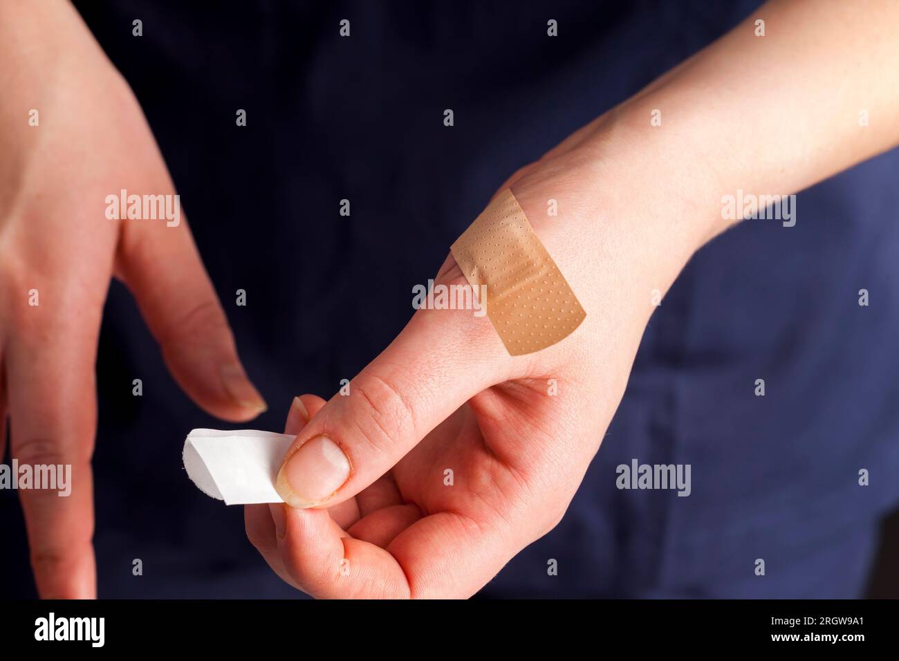 a woman in medical clothing puts a band on her hand, a woman doctor ...