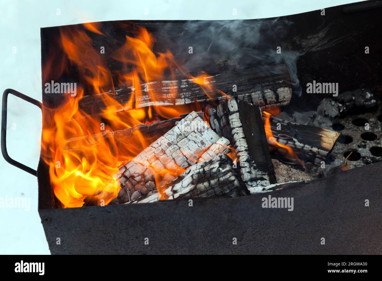 cooking traditional East Asian food on the fire of the flame, burning ...