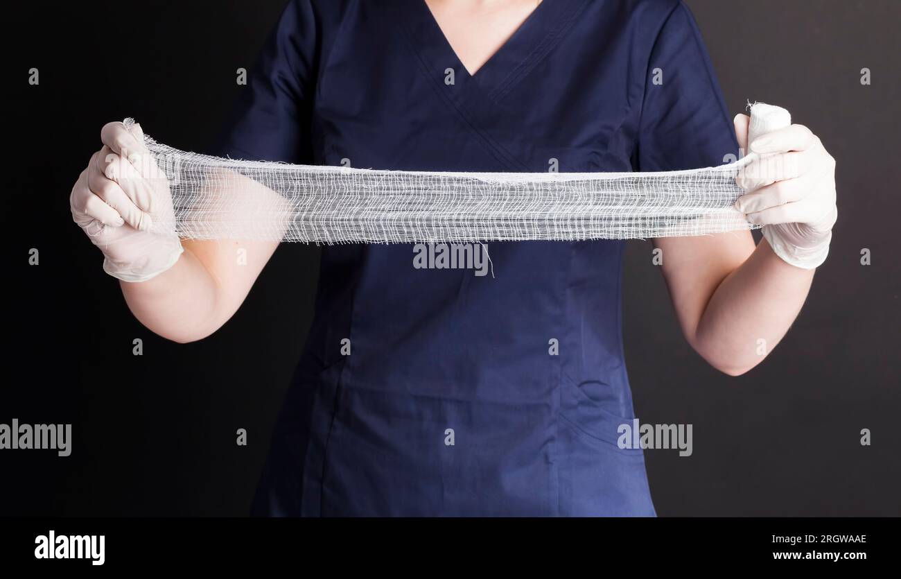 medical white bandage in the hands of a female doctor, a man in medical ...