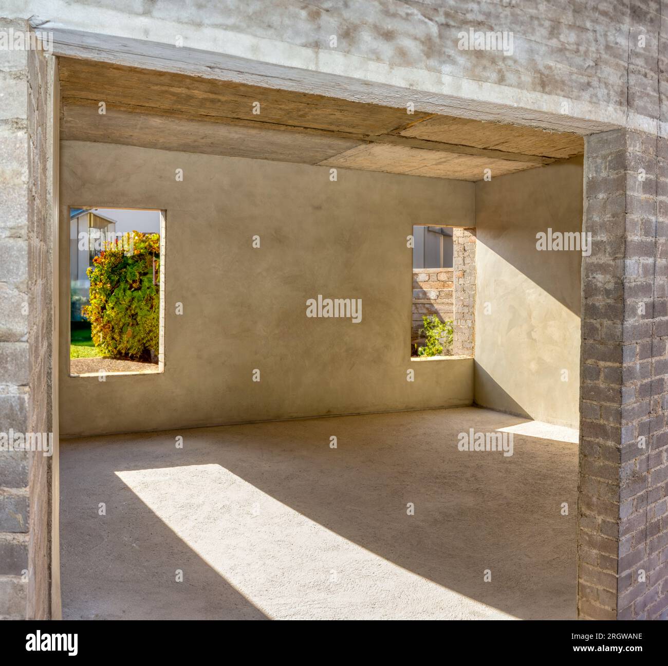 unfinished room construction work, cement bricks walls , empty windows ...