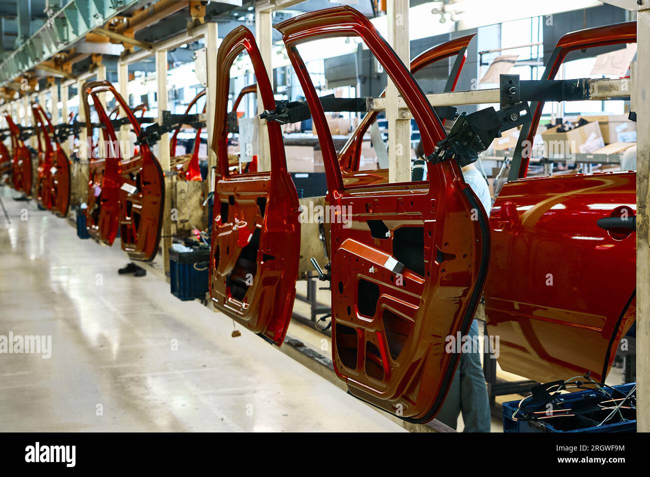 Car doors painted shiny red color in assembling workshop Stock Photo ...