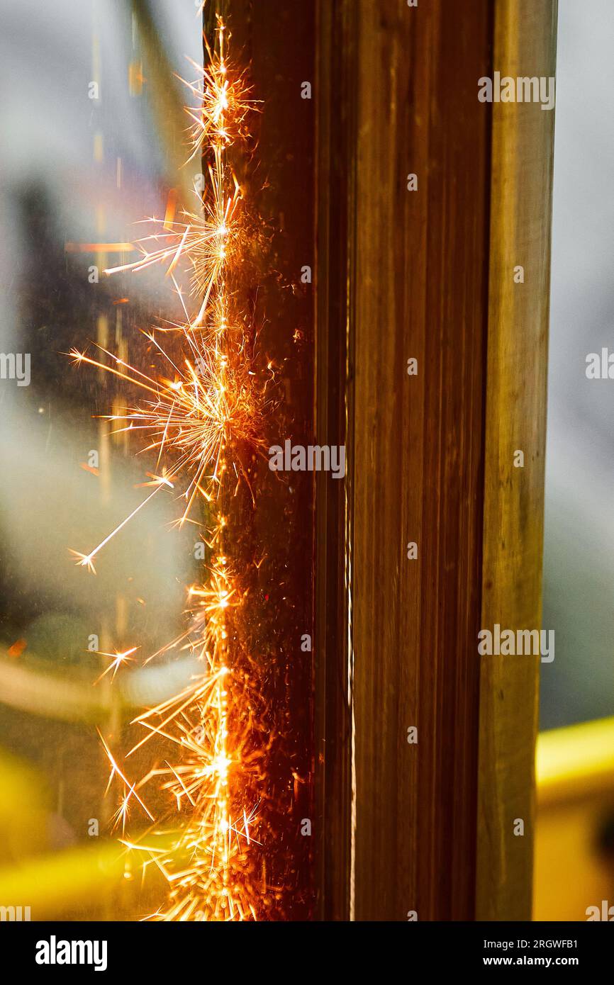 Electric erosion machining of metal beam with bright sparks Stock Photo ...