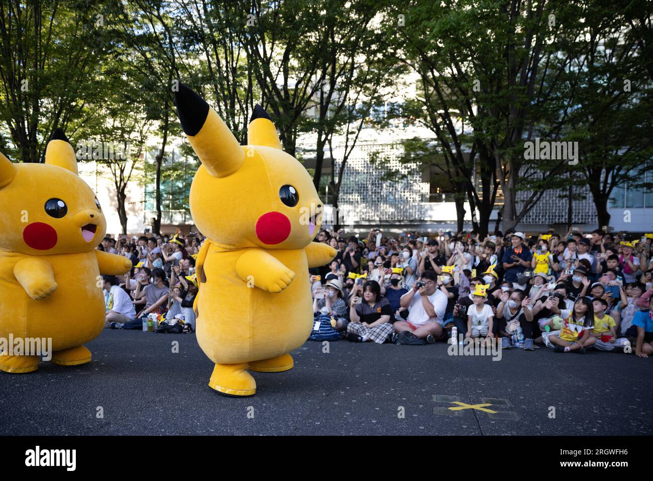 Yokohama, Japan. 11th Aug, 2023. Pikachus walk and dance in front of ...