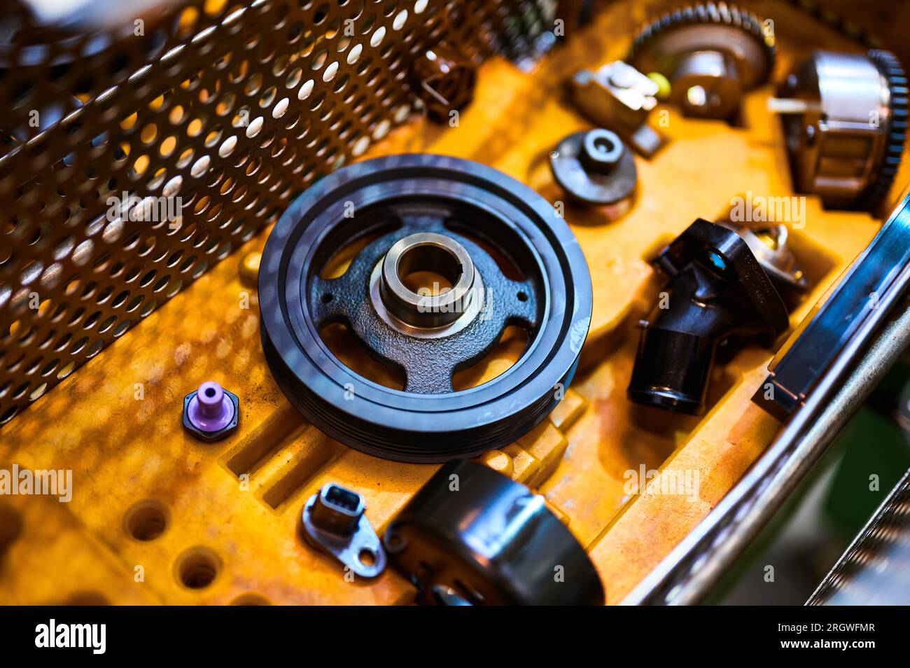 Various parts for assembly during the assembly of an automobile engine ...