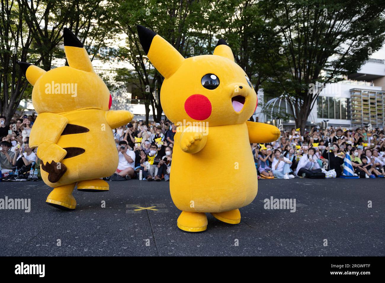Yokohama, Japan. 11th Aug, 2023. Pikachus walk and dance in front of ...