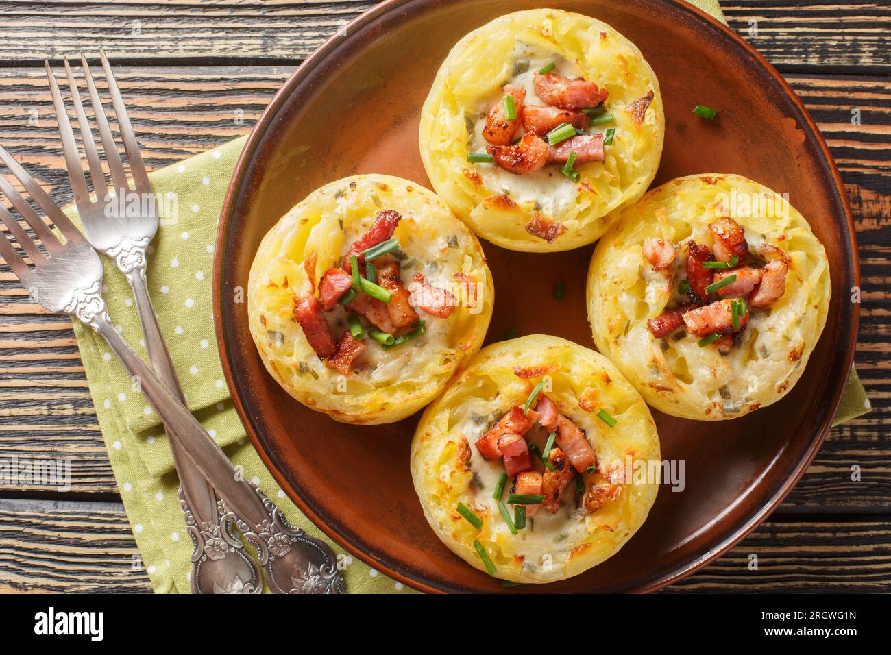 Homemade potato nests stuffed with fried bacon and onions close-up in a ...