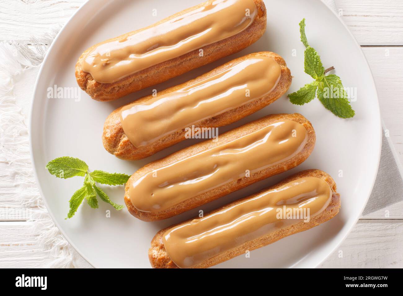 French sweet eclairs with cream filling and topped with soft delicate ...