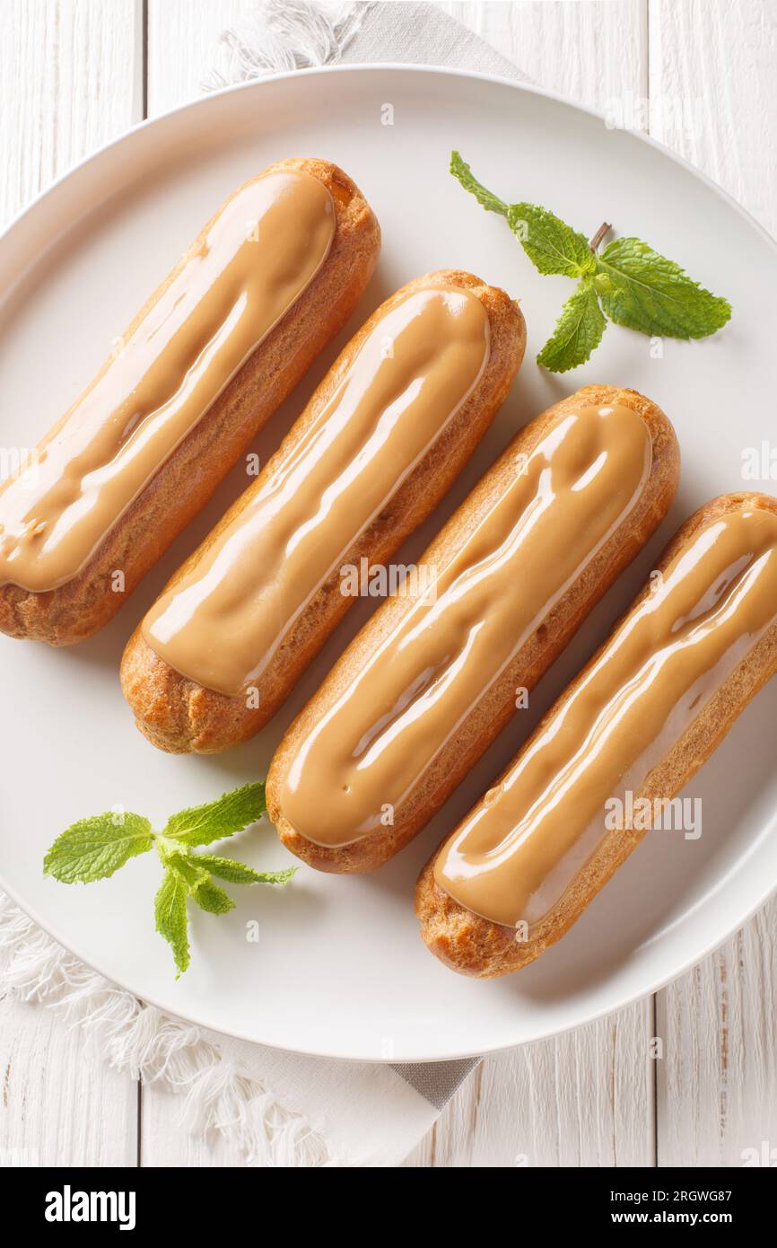 Traditional french eclairs filled with coffee cream and topped with ...