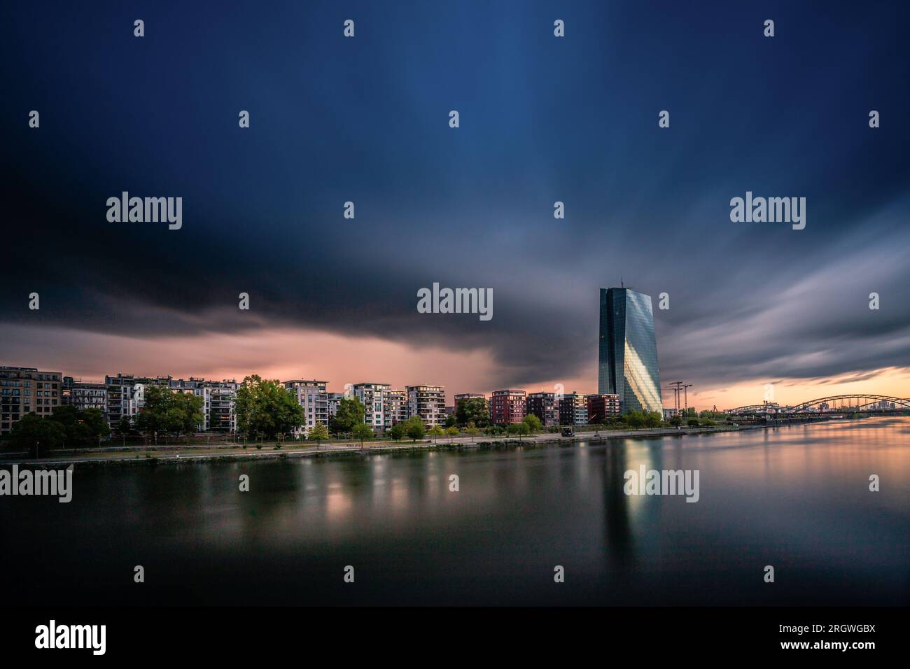 Sunset in Frankfurt am Main. Skyline wedged under a steel bridge. Right ...
