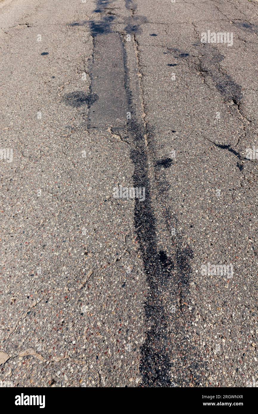 repair of a broken and damaged paved road, the road has many defects ...
