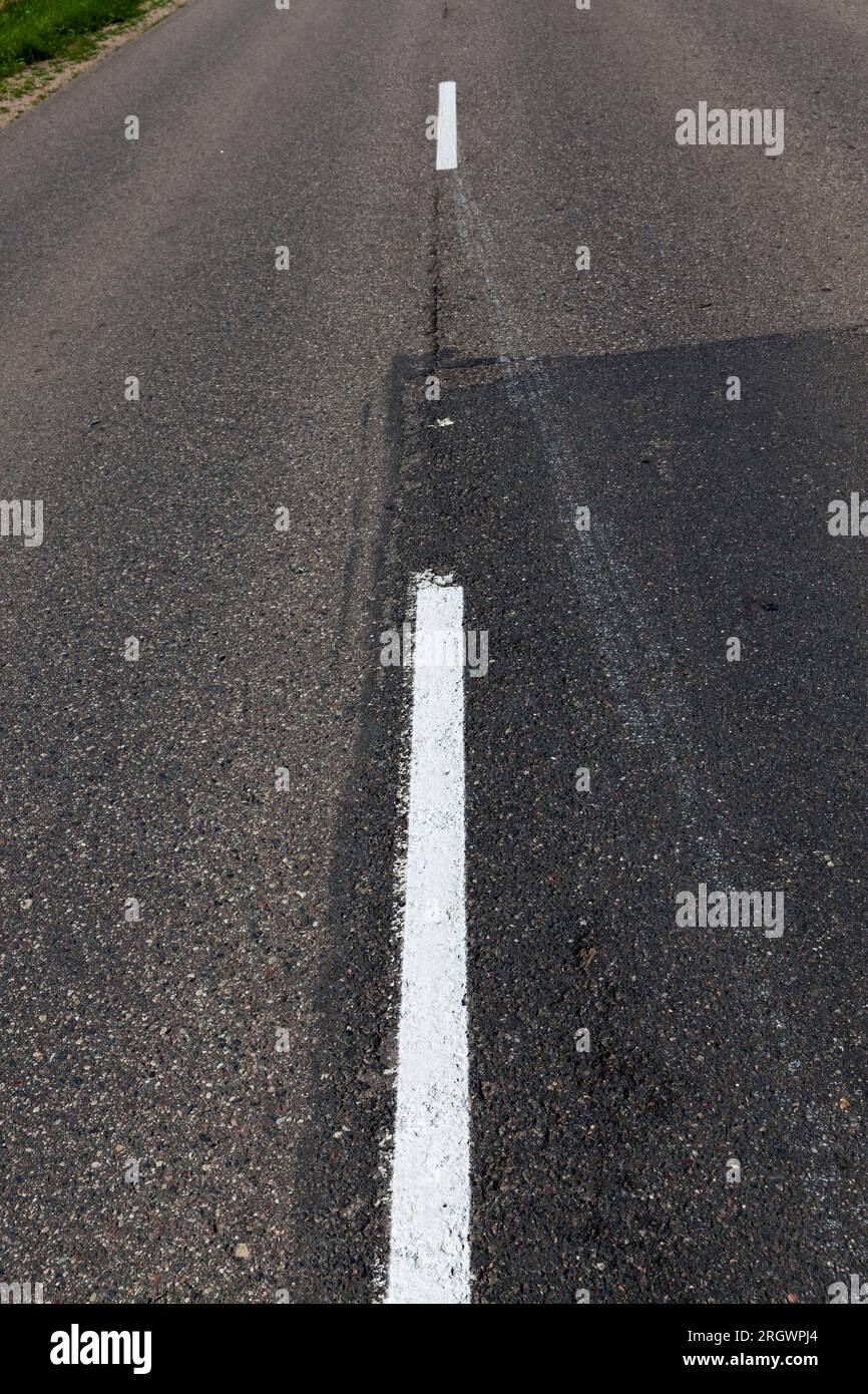painted with white paint automobile road markings, paved road with ...